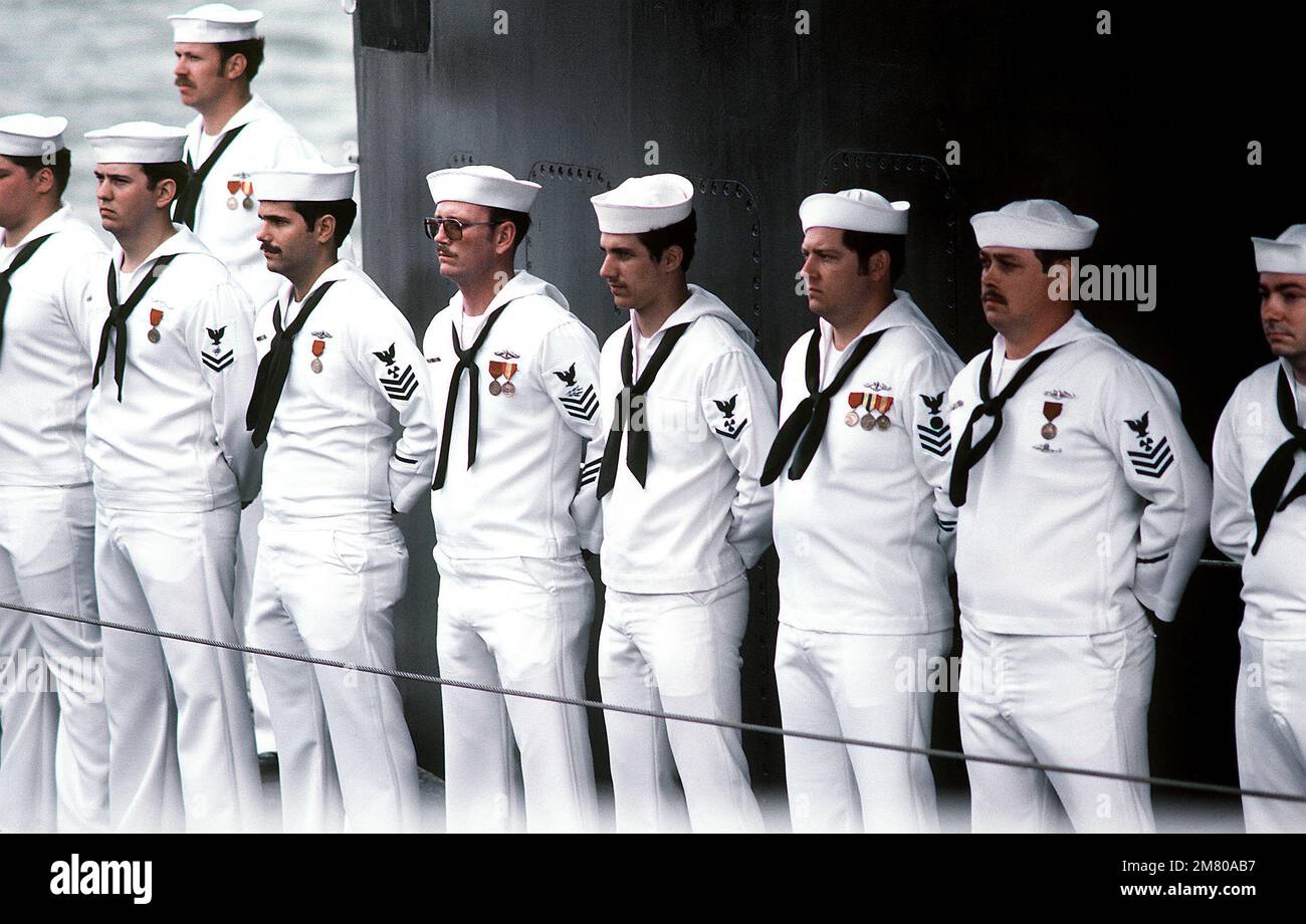 Crewmen stand at attention on the deck of the nuclear-powered attack ...