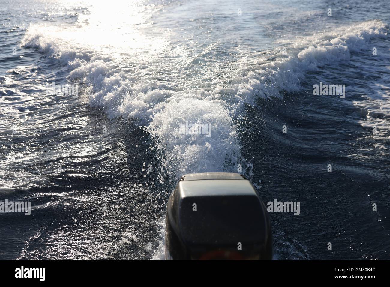 Boat engine and water trail with waves and foam behind it Stock Photo ...