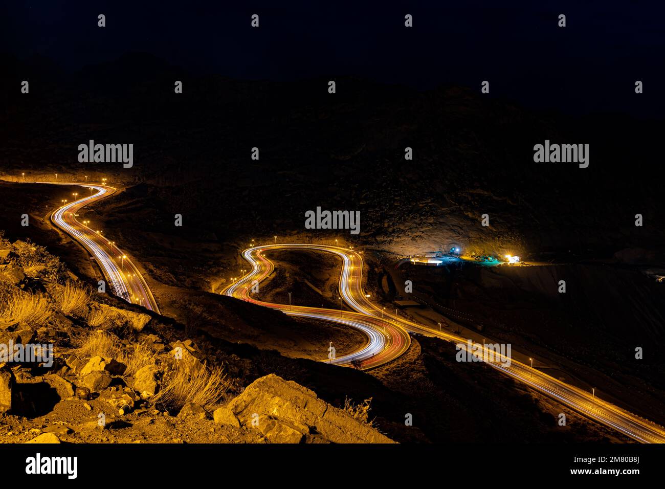A high-angle view of long exposure shots of lights over a highway at ...