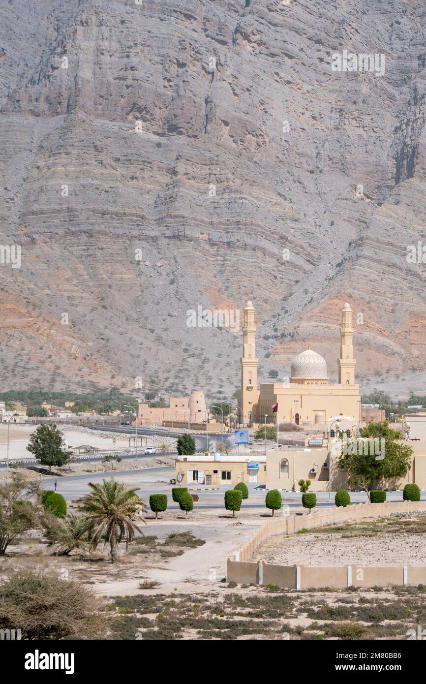 Bukha, Oman - 04.01.2018: Mosque with to minarets and a small fort with ...