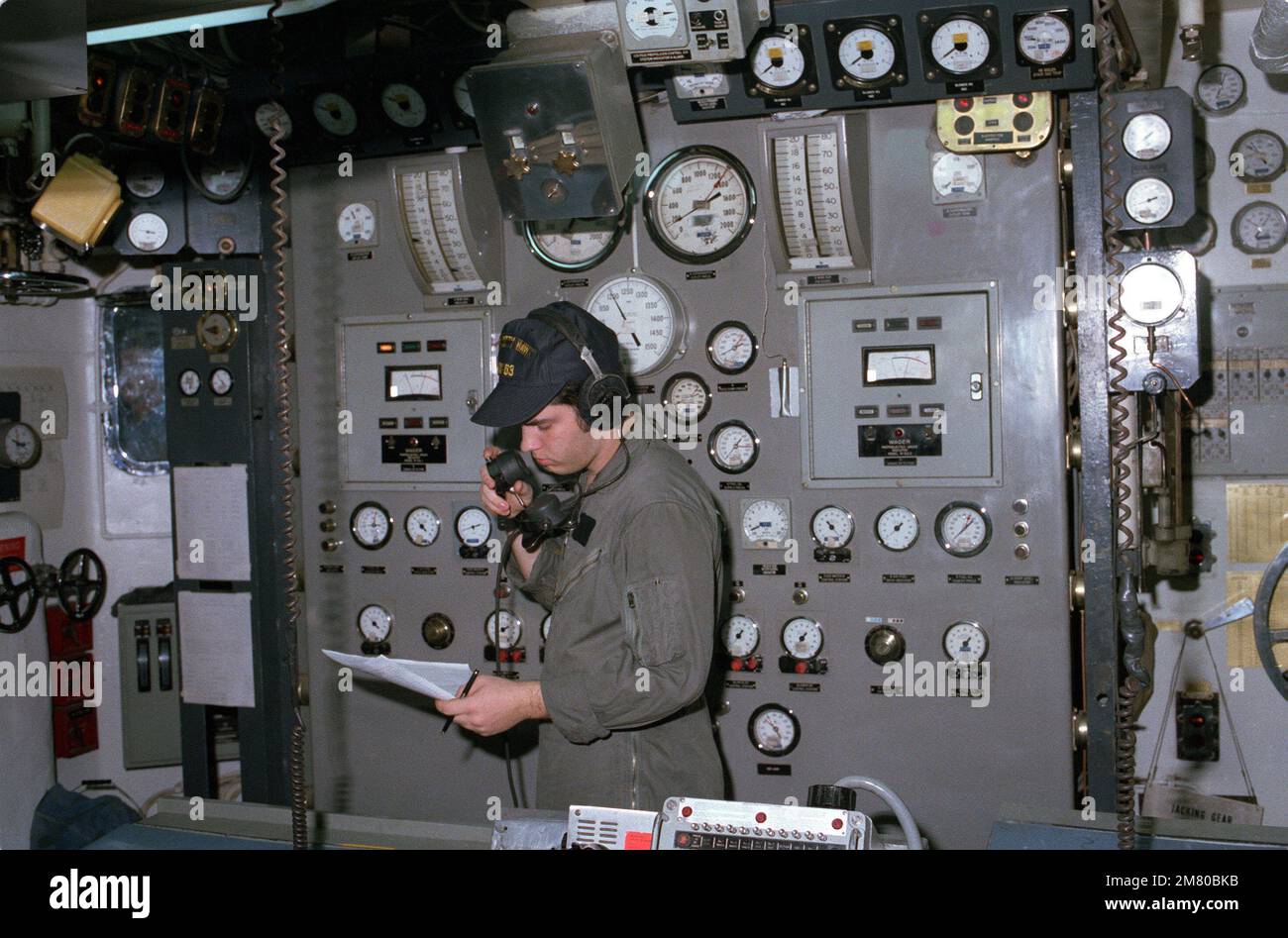 A crew member monitors boiler activity in the control booth of the No ...