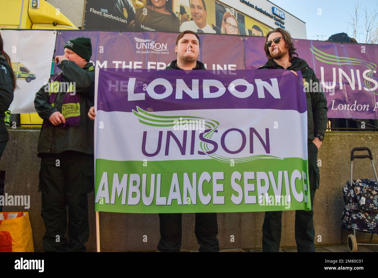 Ambulance workers hold a Unison (trade union) banner at the picket ...