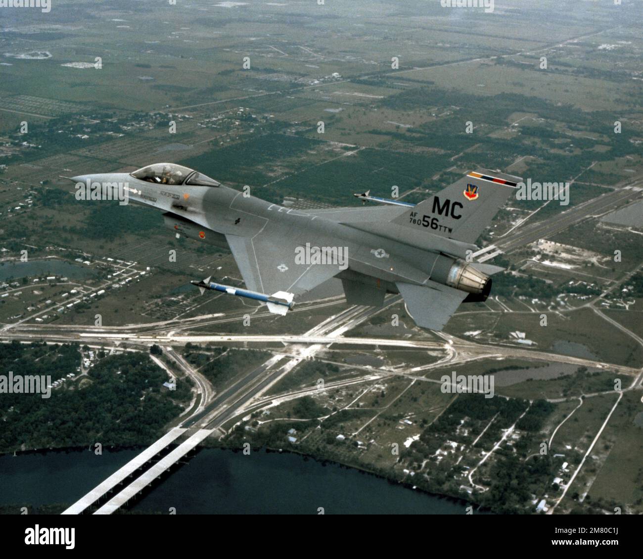 An air-to-air, left-rear view of an F-16 Fighting Falcon aircraft over ...