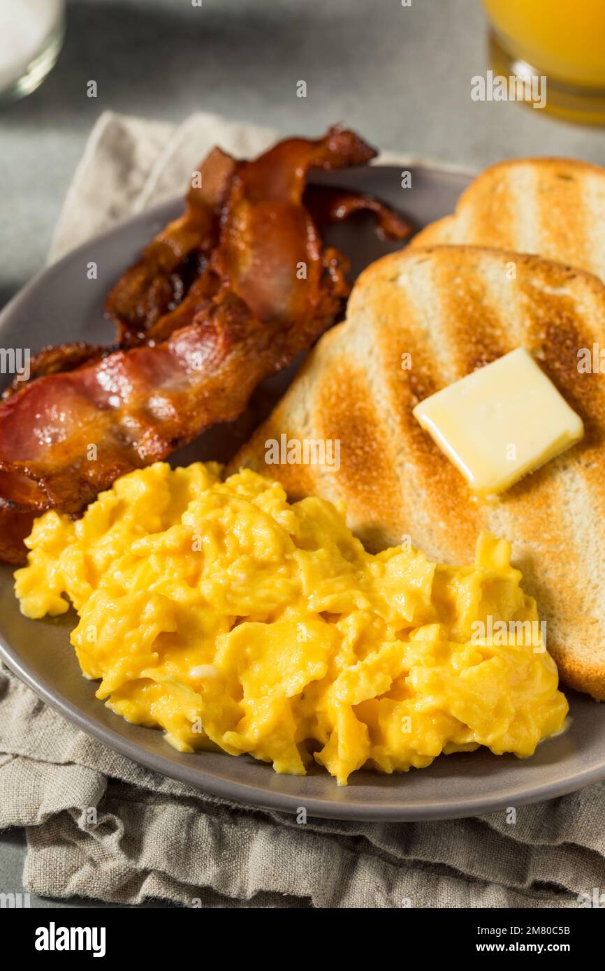 Homemade American Scrambled Egg Breakfast with Bacon and Toast Stock Photo - Alamy