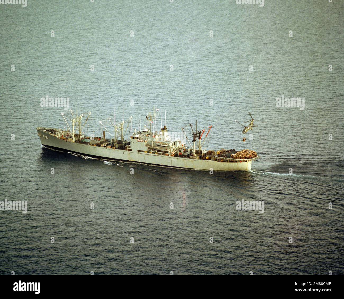 Aerial port view of the store ship USS RIGEL (T-AF 58) underway ...