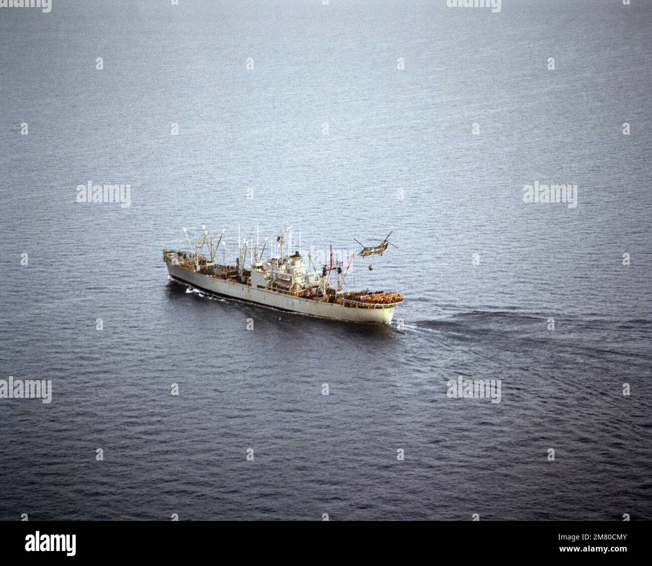 A Sea Knight helicopter departs the store ship USS RIGEL (T-AF 58) with ...
