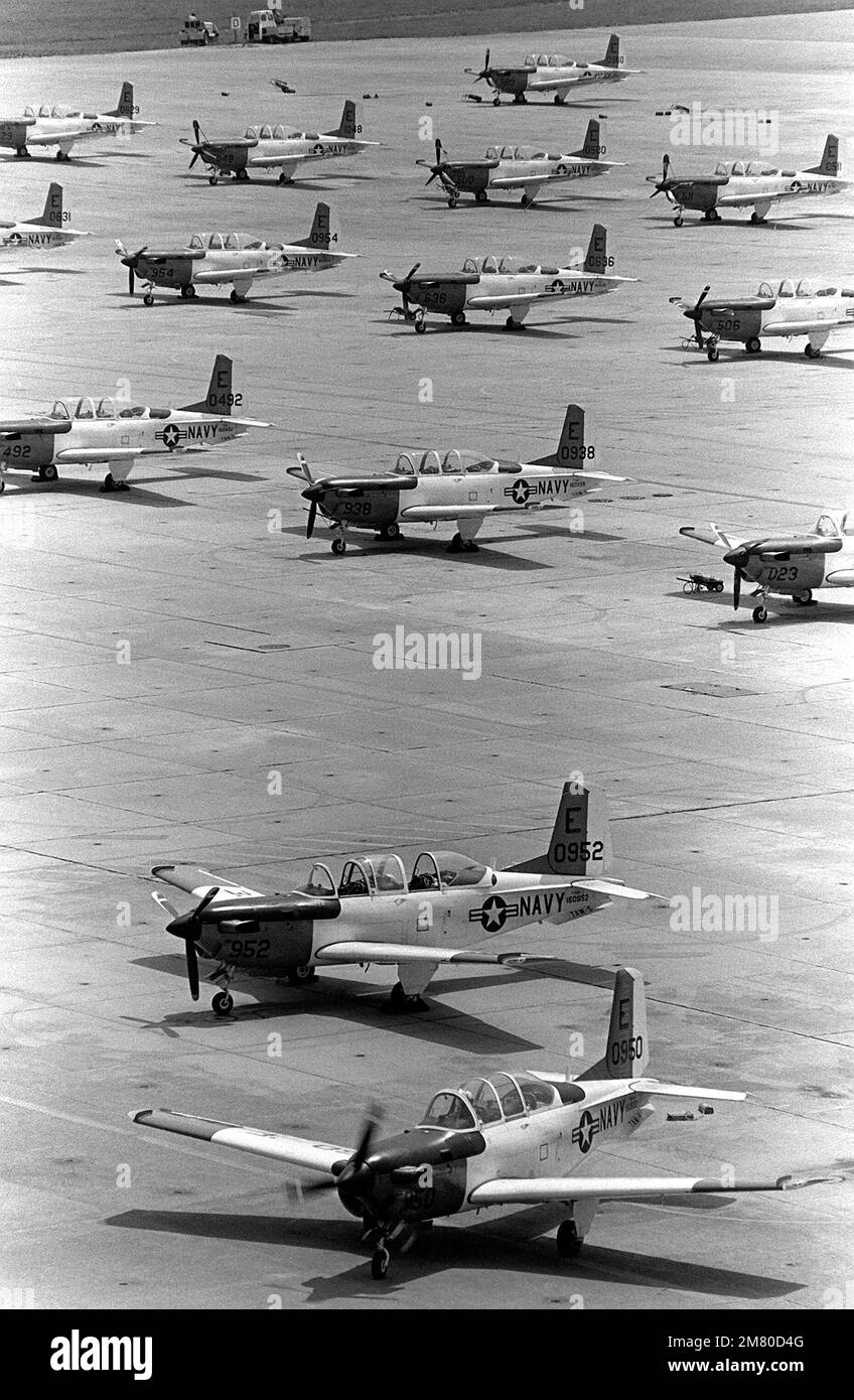 A view of a T-34C Mentor trainer aircraft parked on the flight line ...