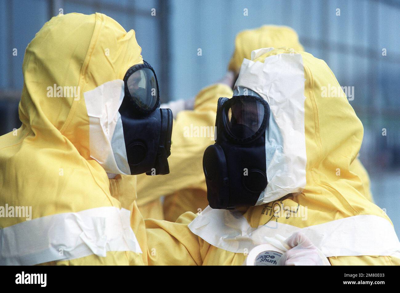 Members of the Disaster Response Force use masking tape to seal any ...