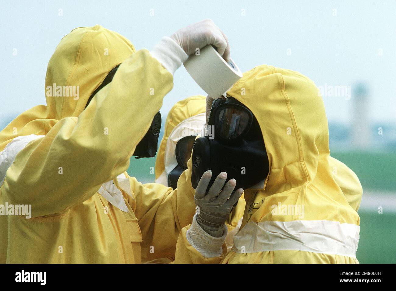 Members of the Disaster Response Force use masking tape to seal any ...