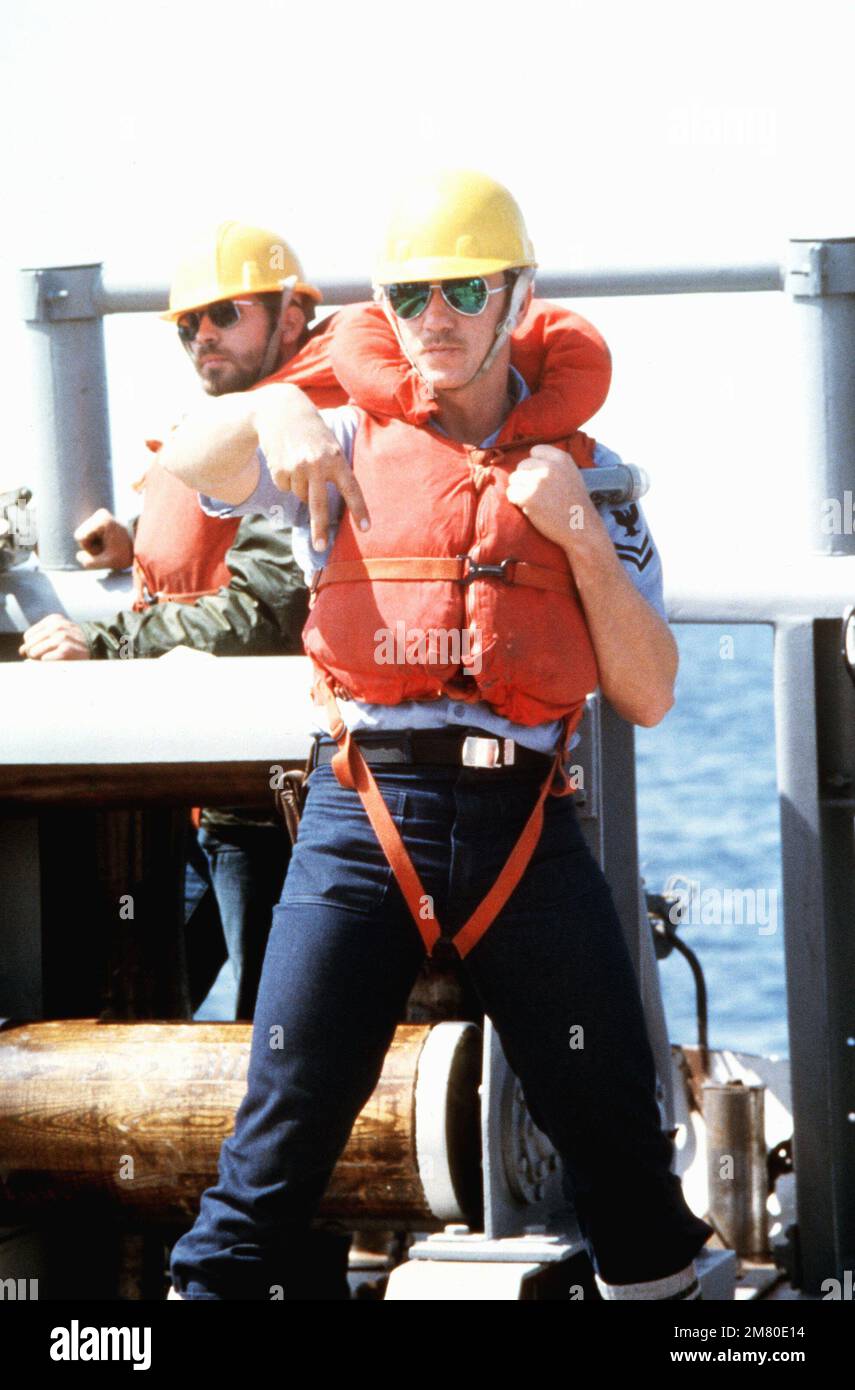 The rig captain uses hand signals to direct sweeping exercises aboard ...