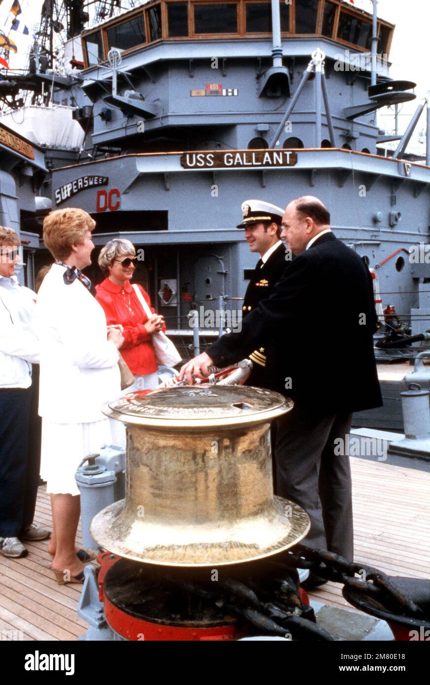 An officer conducts a tour for visitors aboard the ocean minesweeper ...
