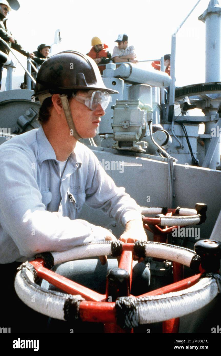 A winch operator waits for orders during sweeping exercises aboard the ...