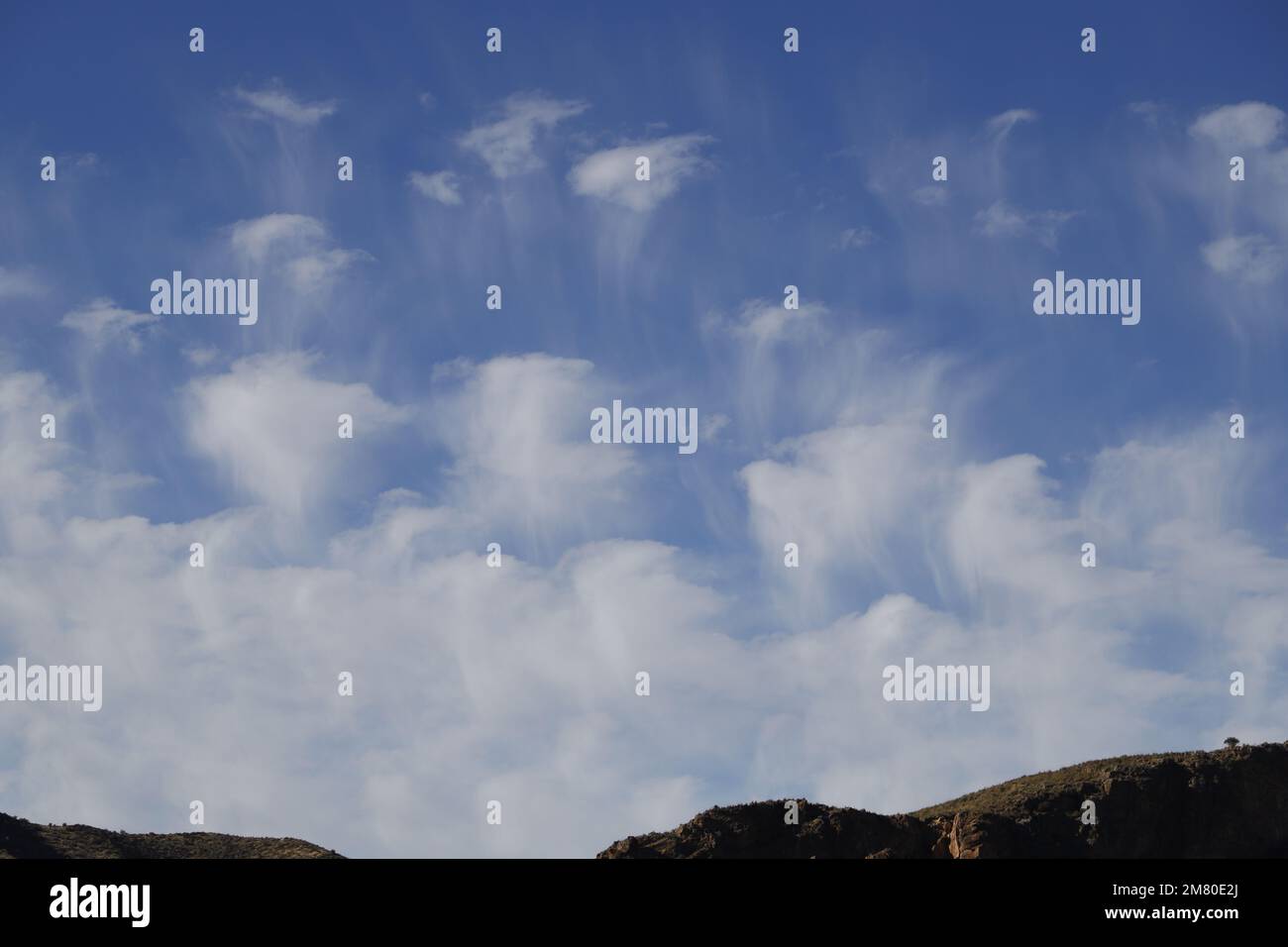 Virga, rain which evaporate in the sky and gives the clouds stripes ...