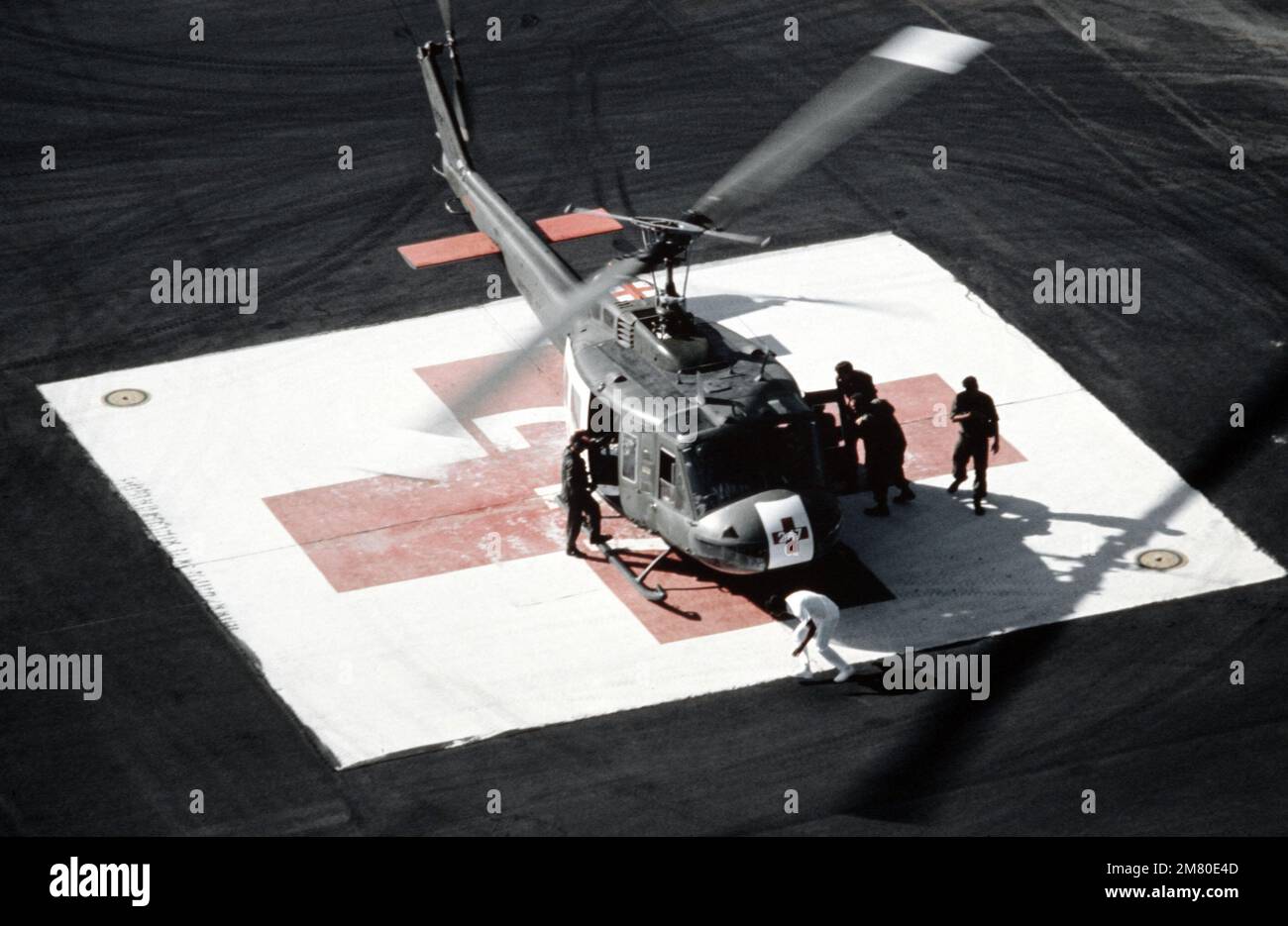 Patients are loaded into a UH-1 Iroquois helicopter for transport to a ...