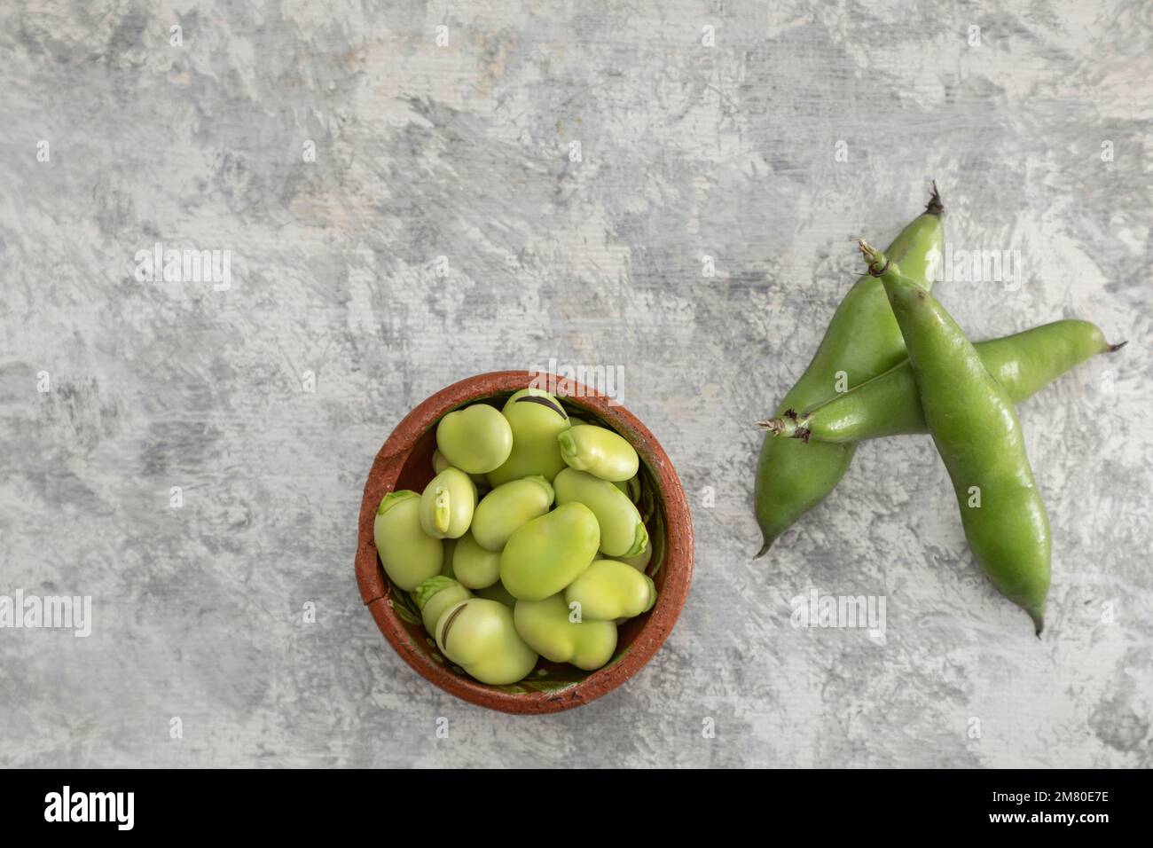composition of peeled and shelled broad beans on a gray texture and ...