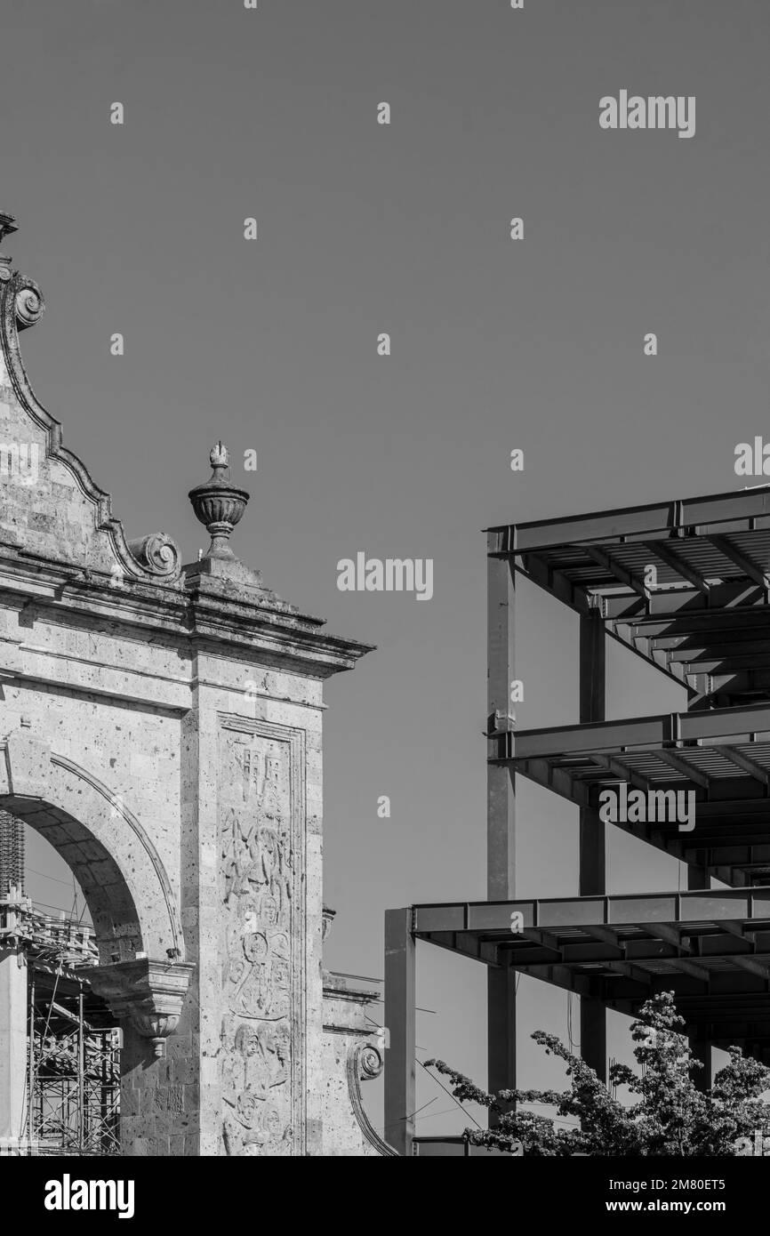 quarry stone arch in contrast to a building under construction in the ...