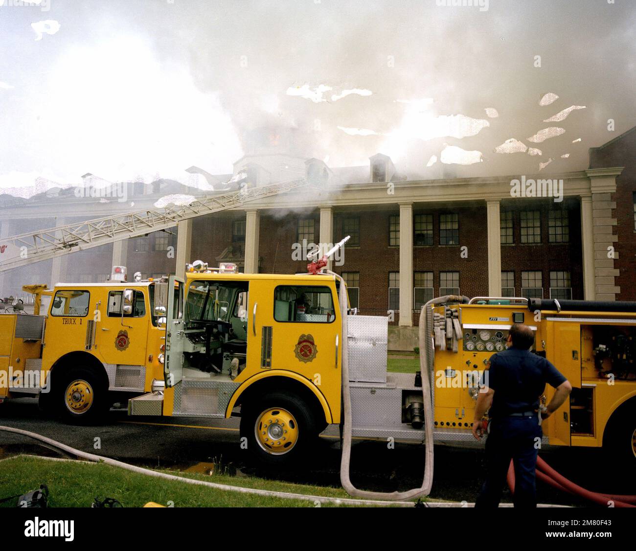 Fire trucks from the Naval District Washington are used to extinguish a ...