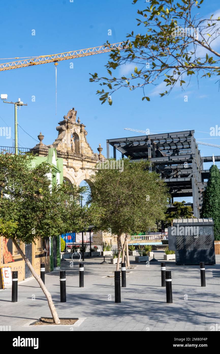 quarry stone arch in contrast to a building under construction in the ...