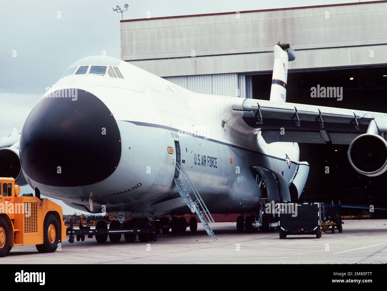 A left front view of a C-5 Galaxy aircraft parked outside a hangar at ...
