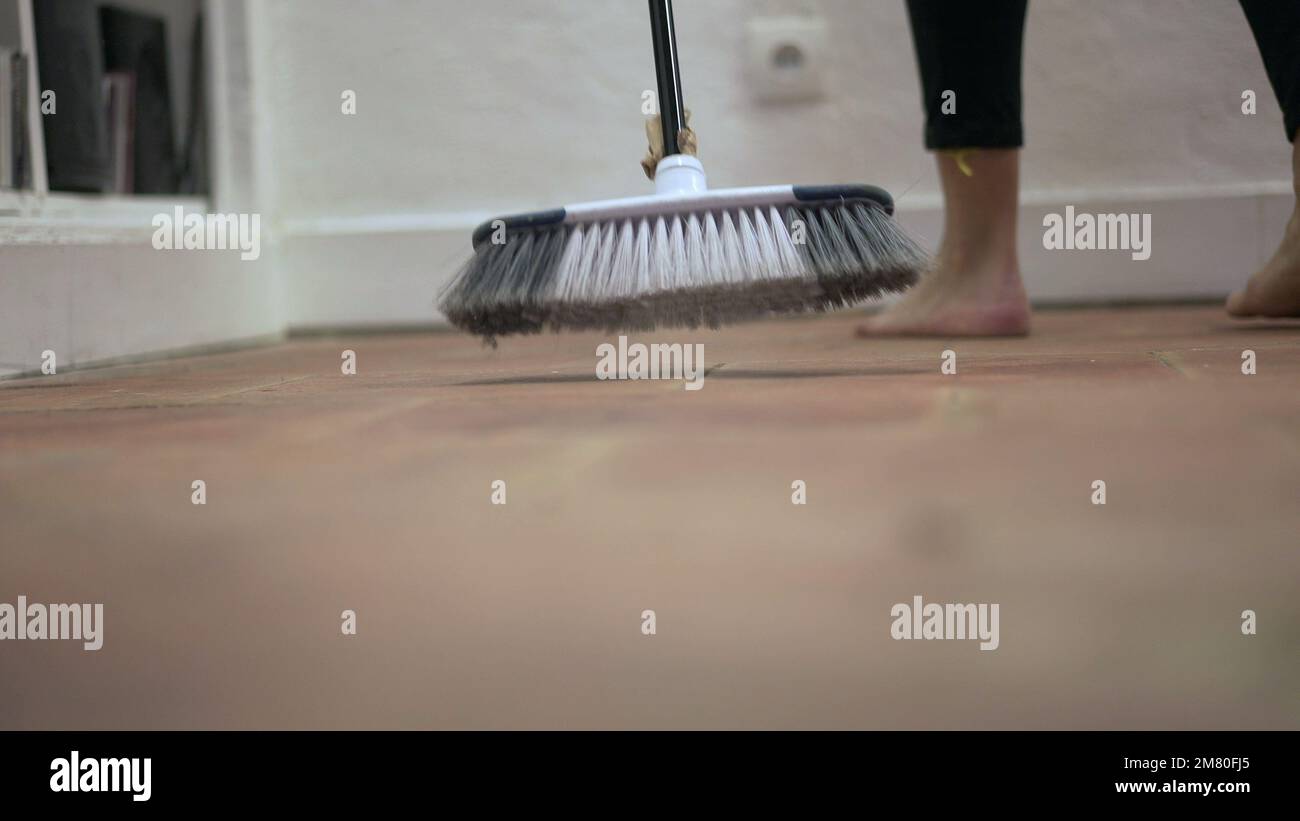 Person sweeping dirty floor with broomstick. Housework Stock Photo - Alamy