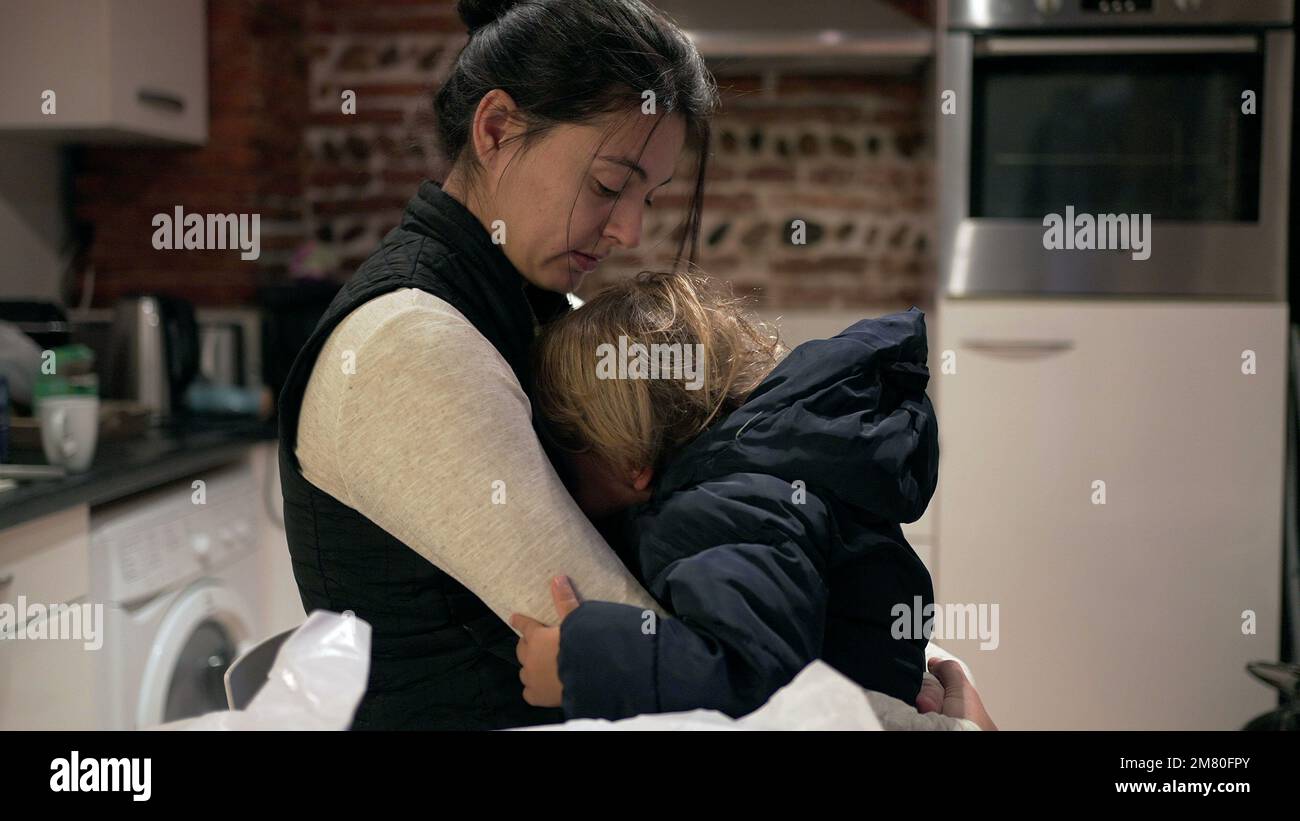 Mother consoling tearful crying baby toddler boy, casual and candid ...