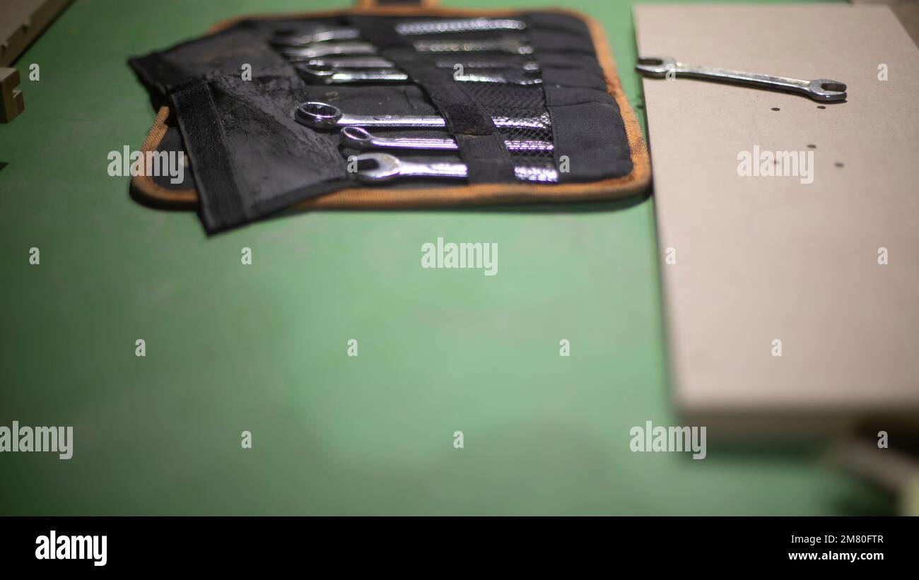 Tool on table. Work desk in workshop. Keys for nuts. Details of ...