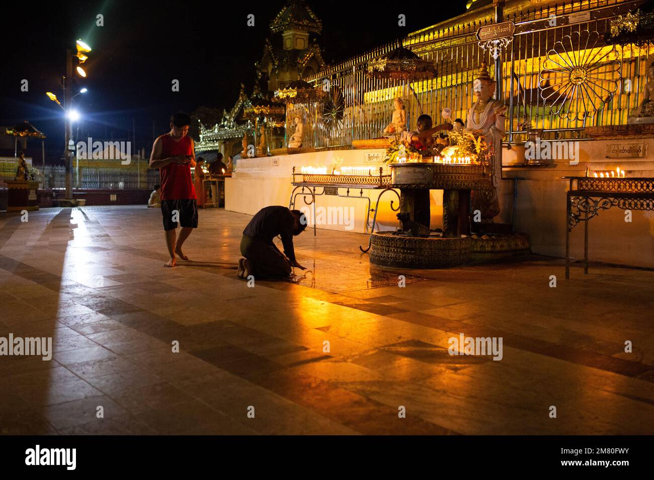 Daily Life Myanmar - people at night near a golden temple in Dawei ...