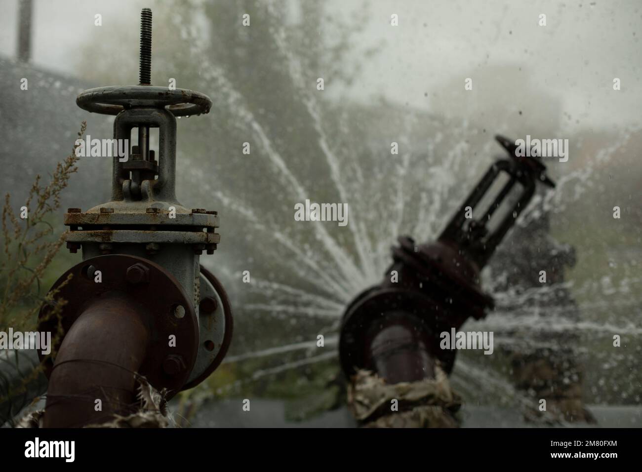 Breakthrough heating pipe. Pipeline accident. Boiling water pours out ...