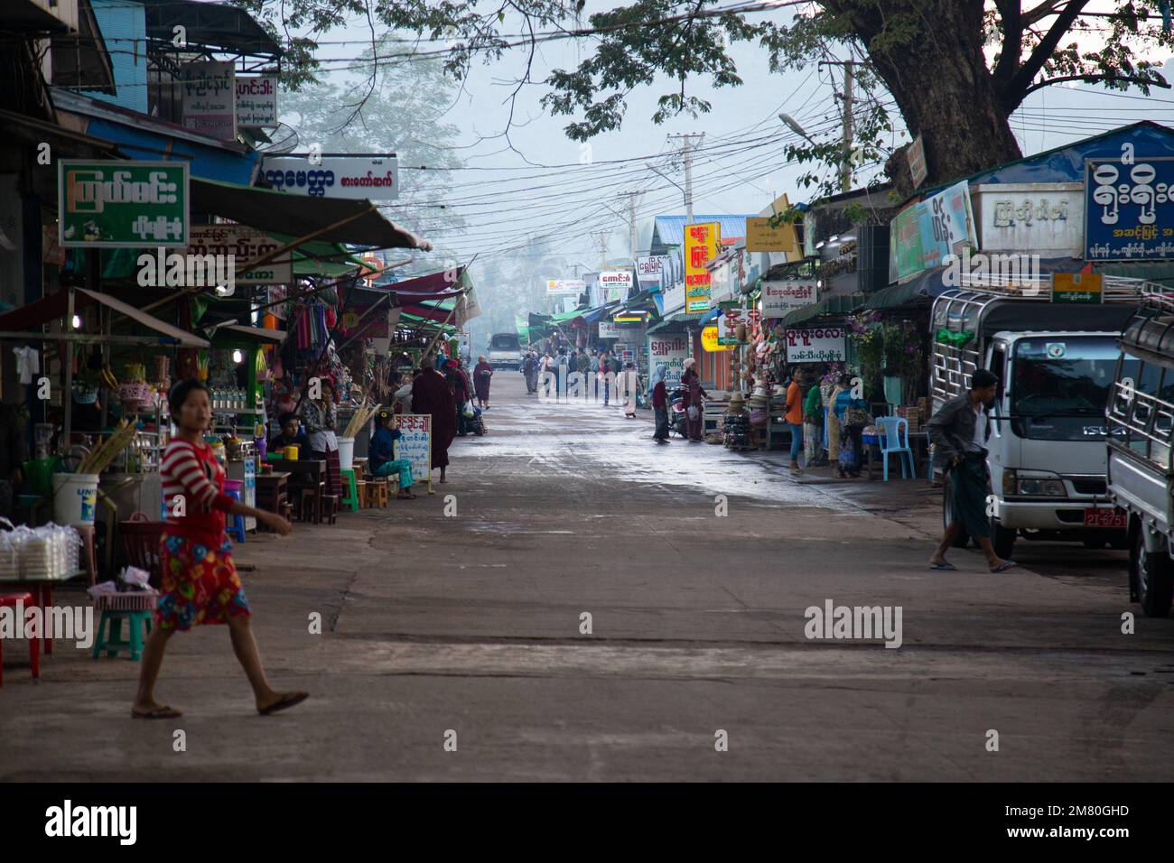 A lady walks through the empty streets on a cool morning in the small ...