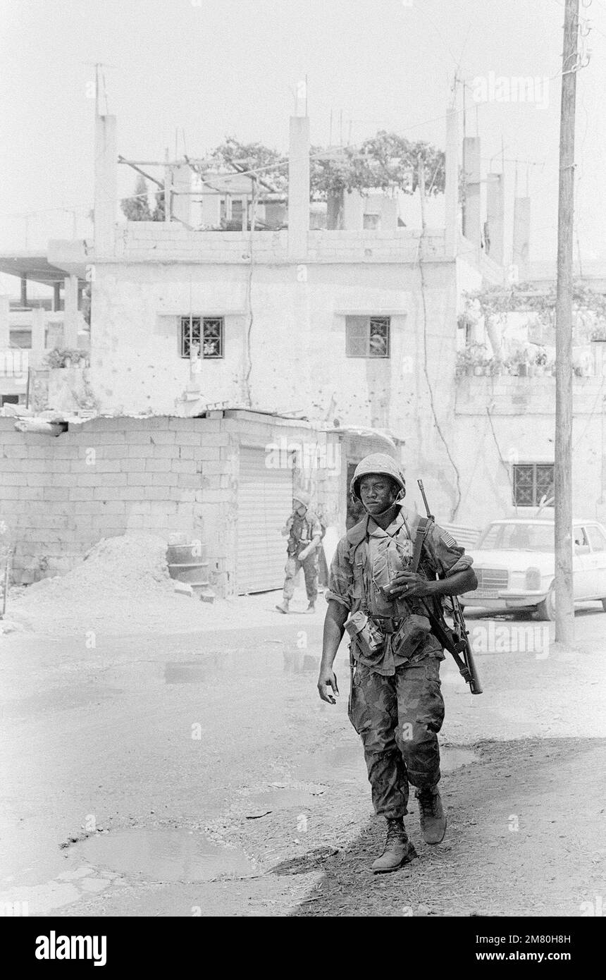 Marines patrol a city street as members of a multinational peacekeeping ...
