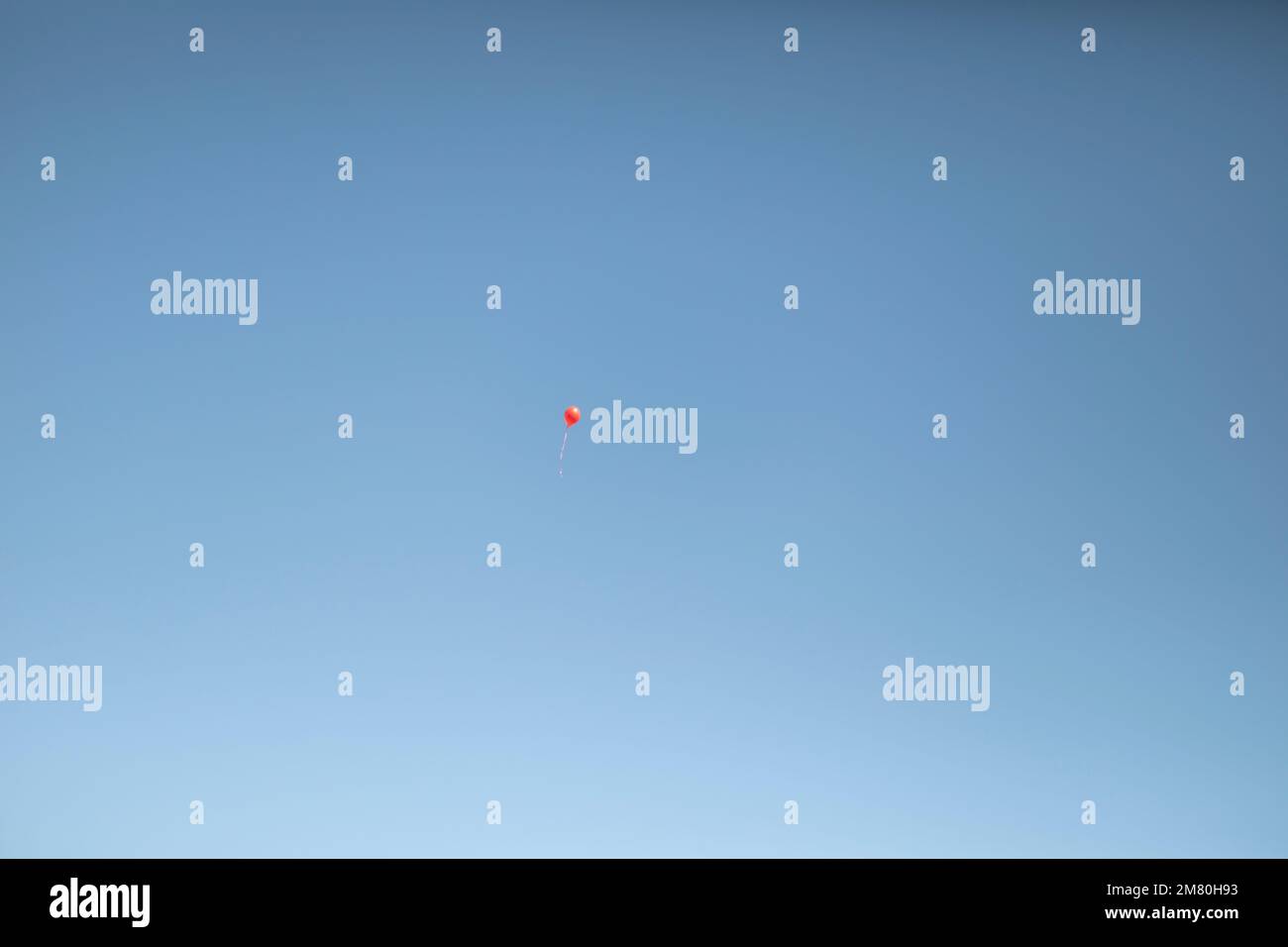 Red ball in blue sky. Balloon flies in air. Flight details Stock Photo ...