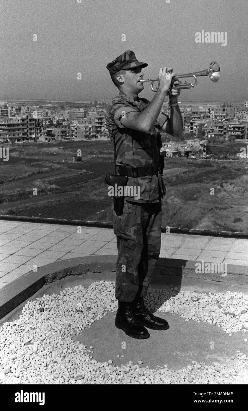 A Marine bugler plays during morning colors. The Marines are ...