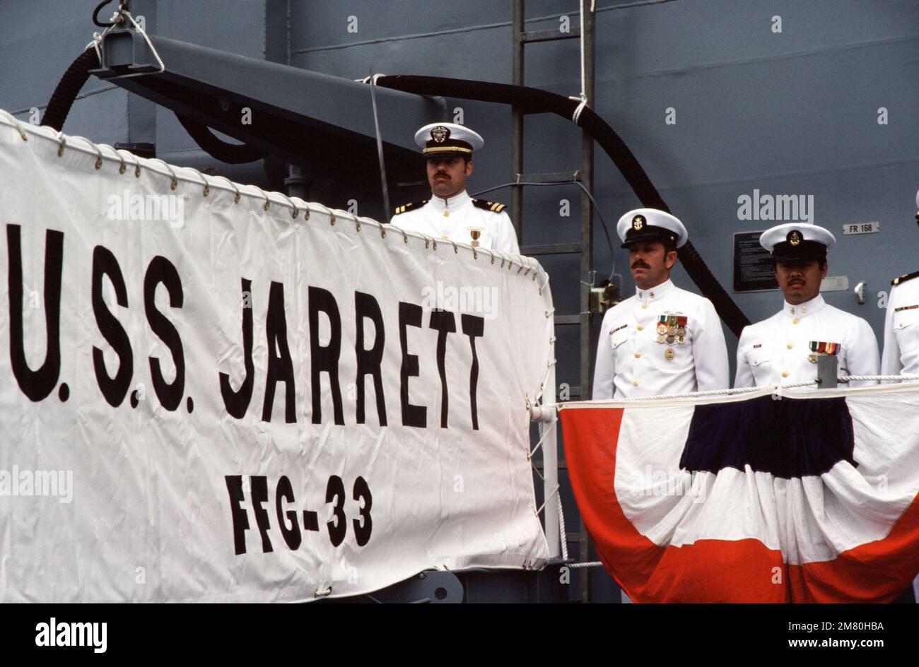 Officers and crewmen stand on the deck of the guided missile frigate ...