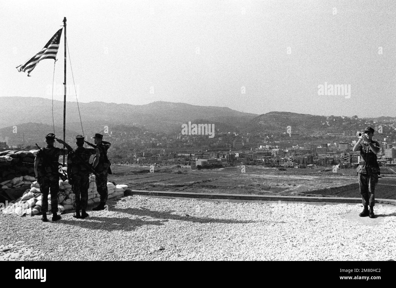 A Marine bugler plays as morning colors takes place. The Marines are ...