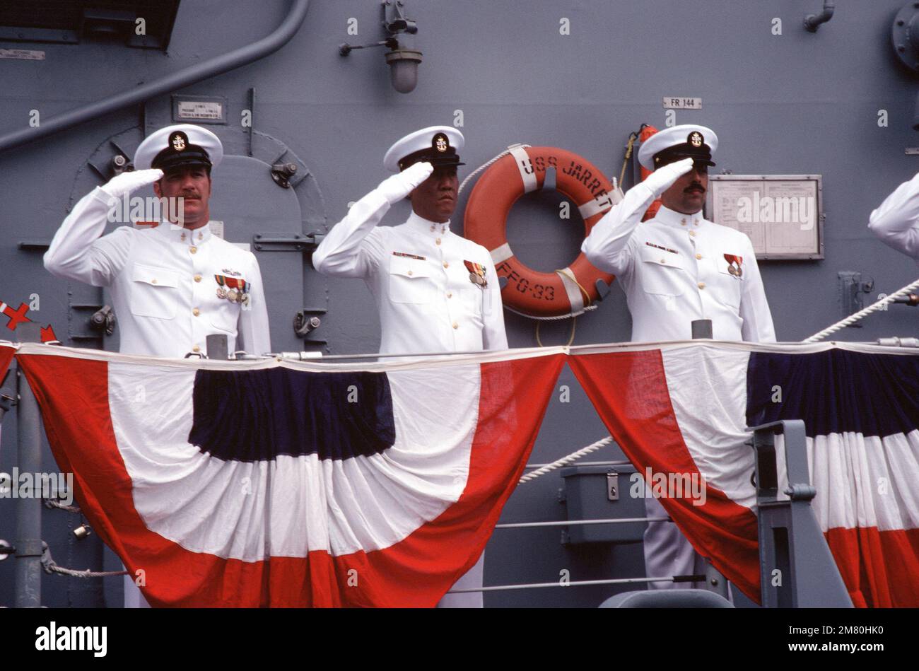 Crewmen stand at attention along the rail of the guided missile frigate ...