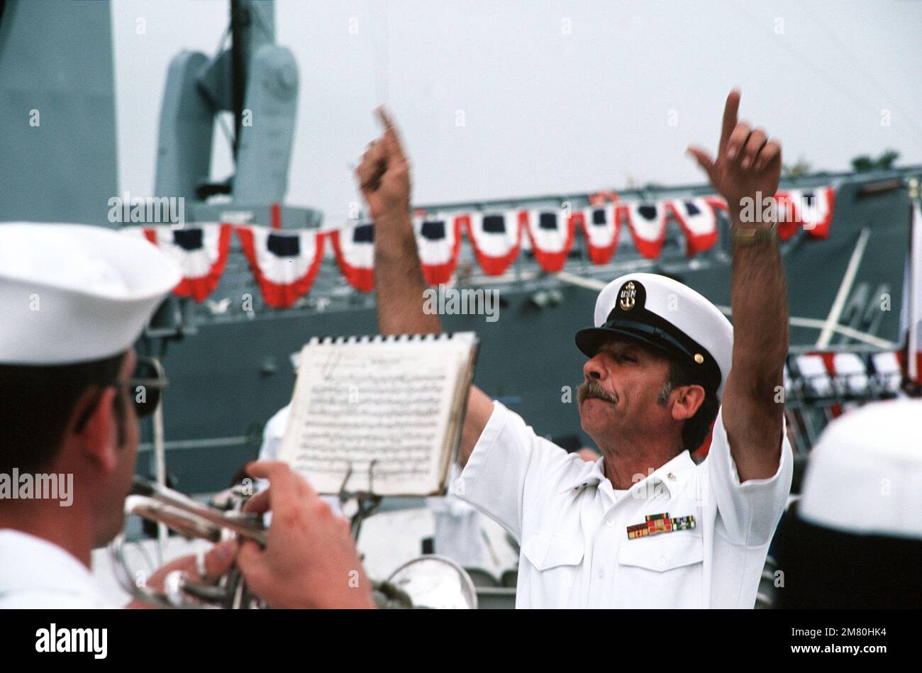 A Navy conductor directs the band during commissioning ceremonies for ...