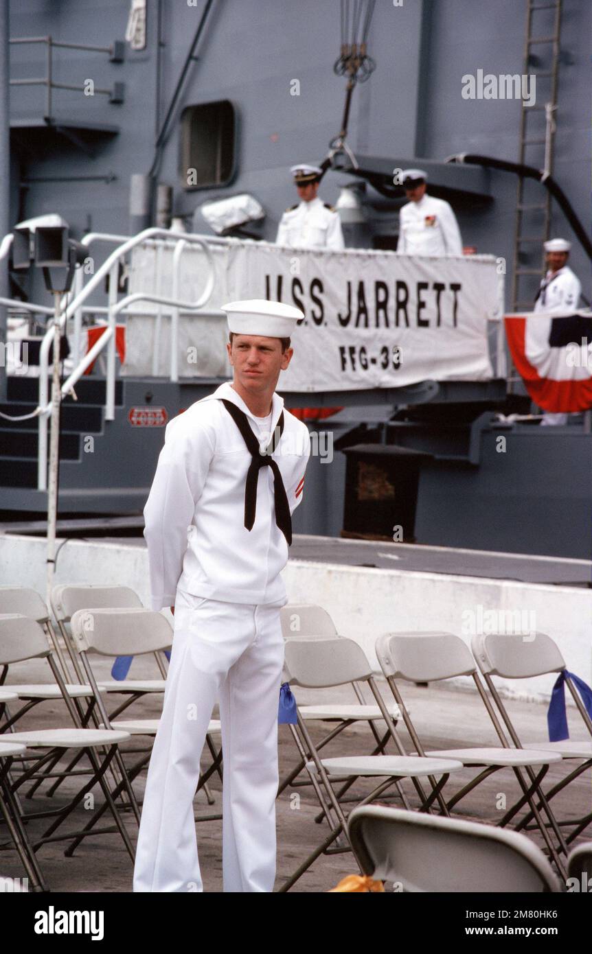 A crewman stands beside empty spectator seats prior to the start of the ...