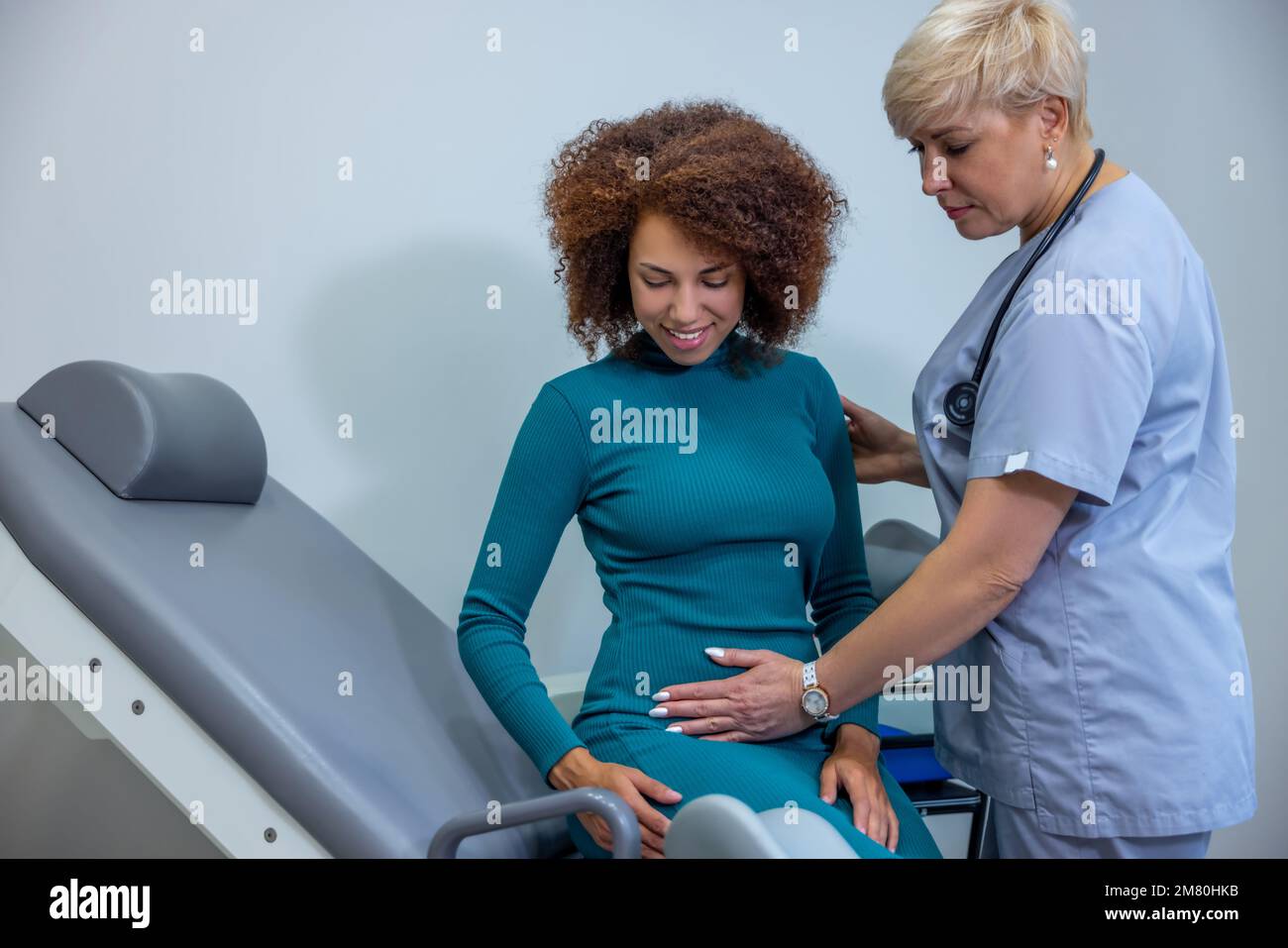 Gynecologist working with a woman sitting on a examination chair Stock ...