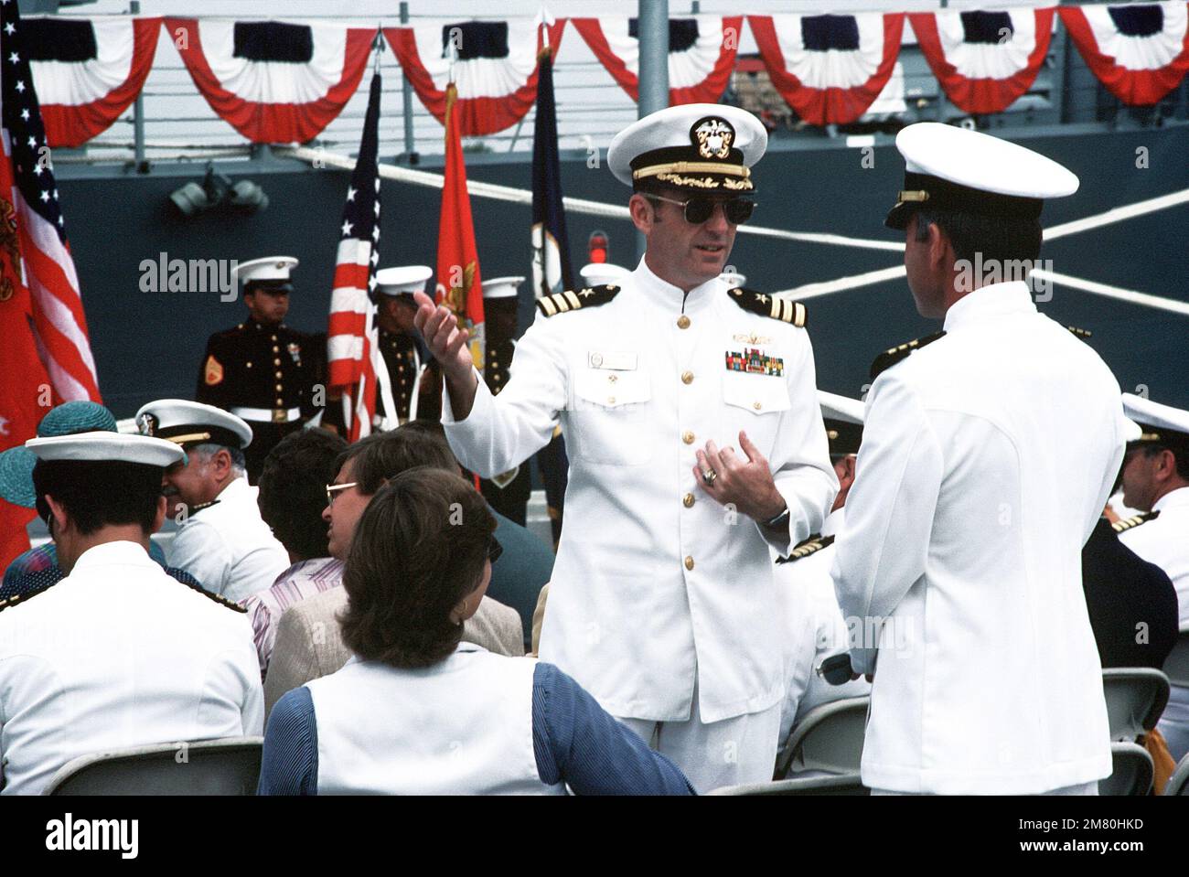 Commander Seymour talks to a guest attending the commissioning ceremony for the guided missile ...