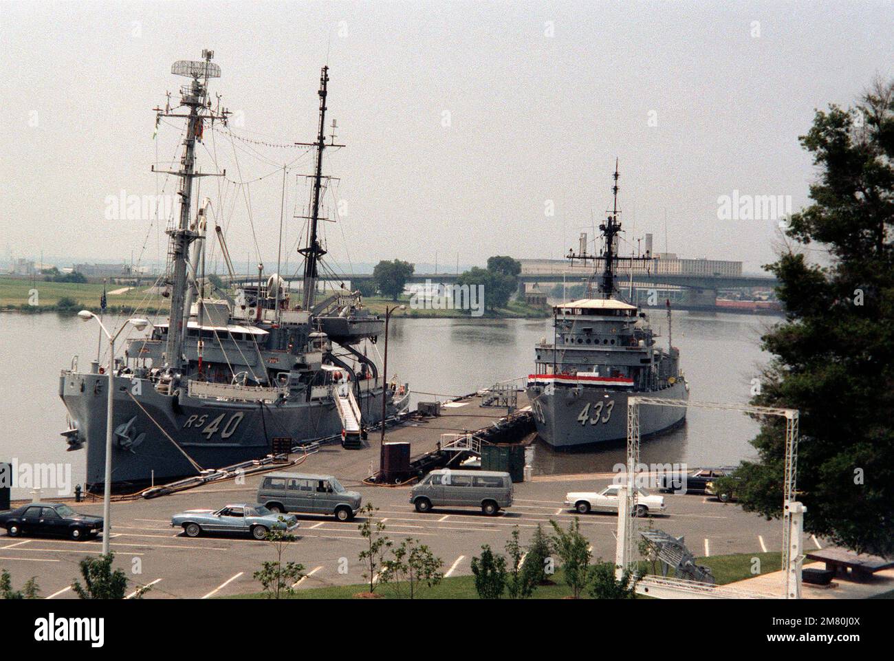Port bow view of the salvage ship USS HOIST (ARS-40), left, and the ...