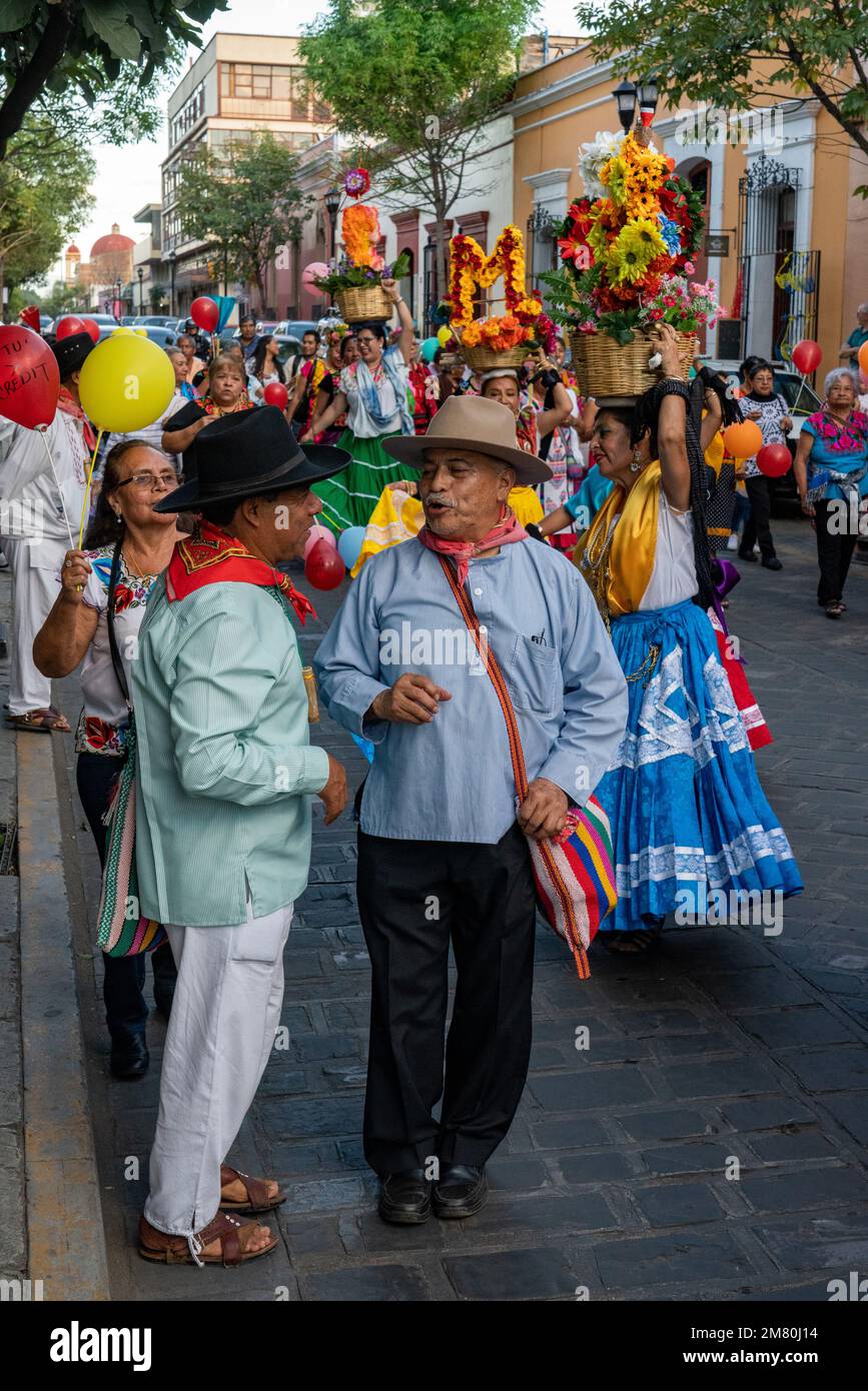 Older people in traditional dress gather for a parade on the streets of ...