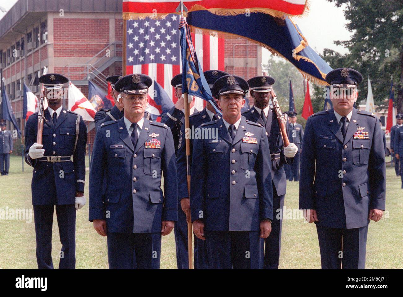 Colonel Wayne Anderson and Colonel Jack Johnson stand at attention as a change of command ...