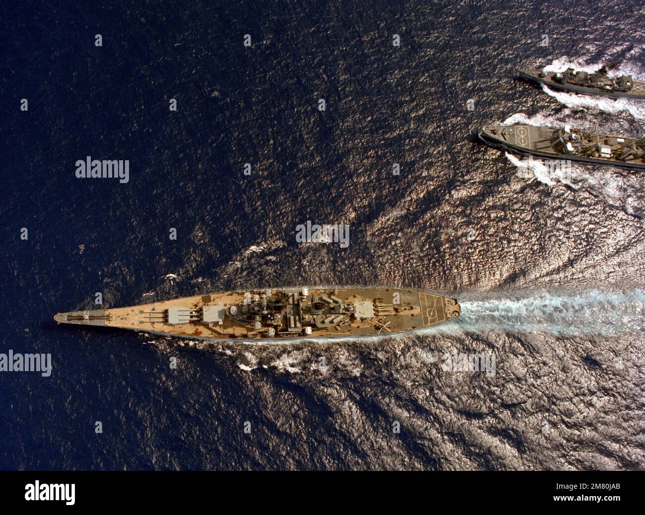 The battleship USS NEW JERSEY (BB-63), left, breaks away from the fleet ...