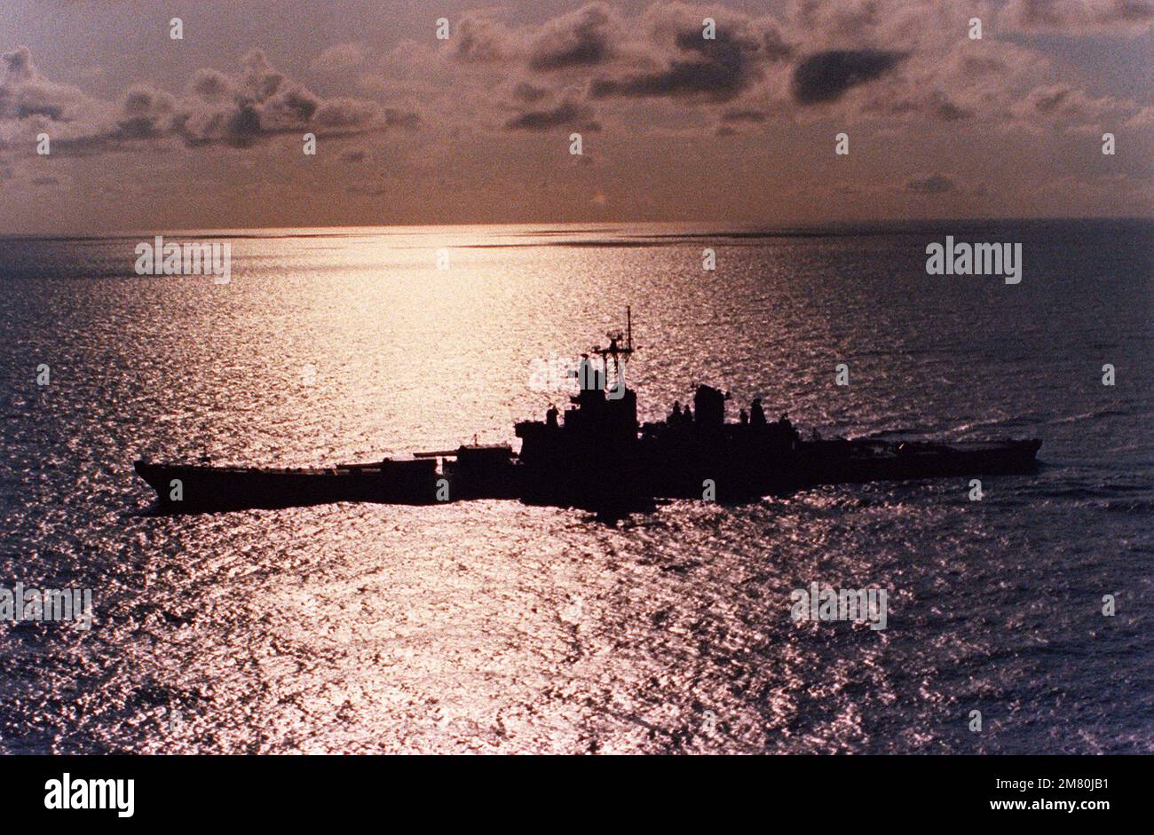A silhouette of the battleship USS NEW JERSEY (BB-62) as the vessel is ...