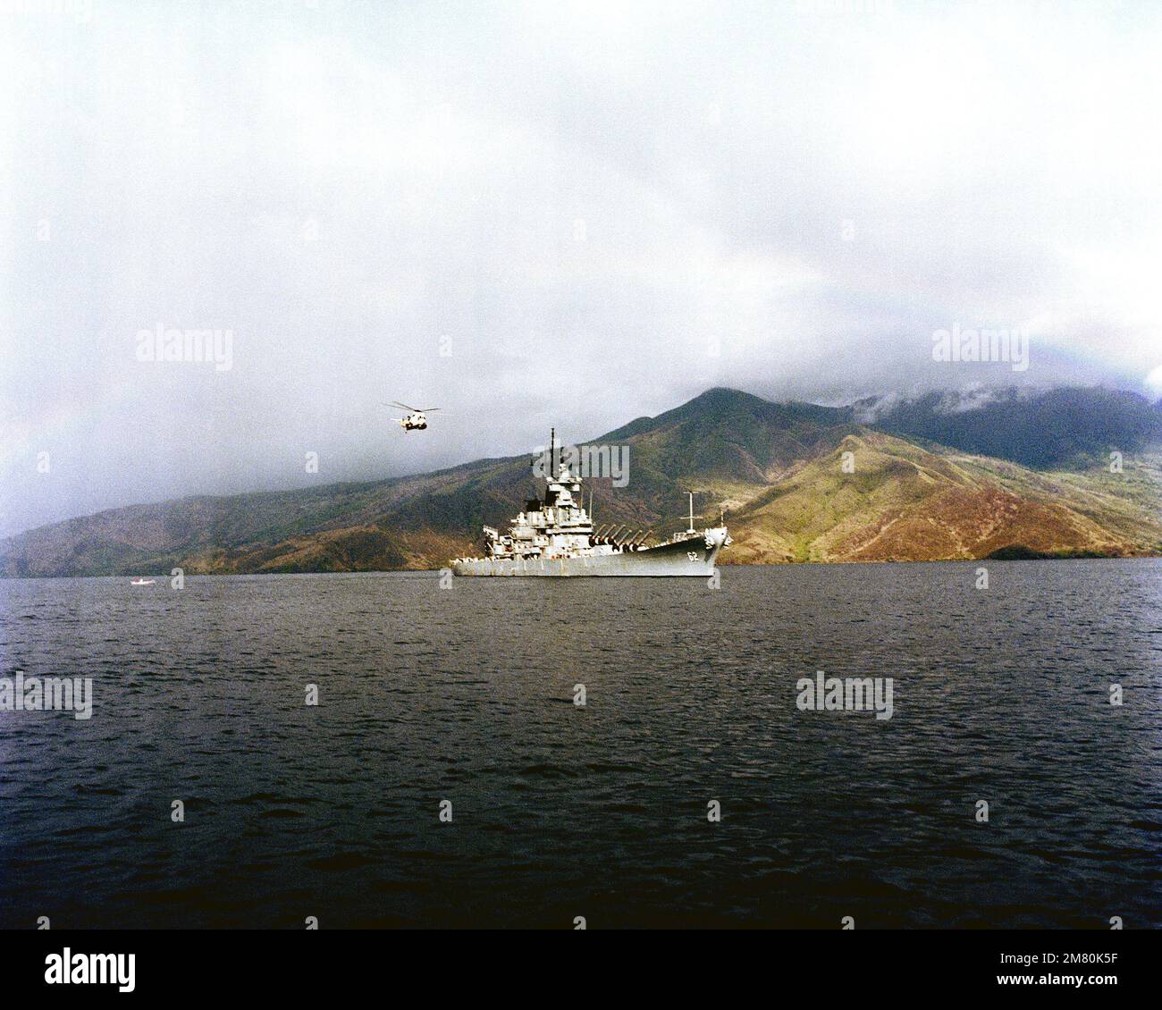 A distant starboard bow view of the battleship USS NEW JERSEY (BB 62 ...