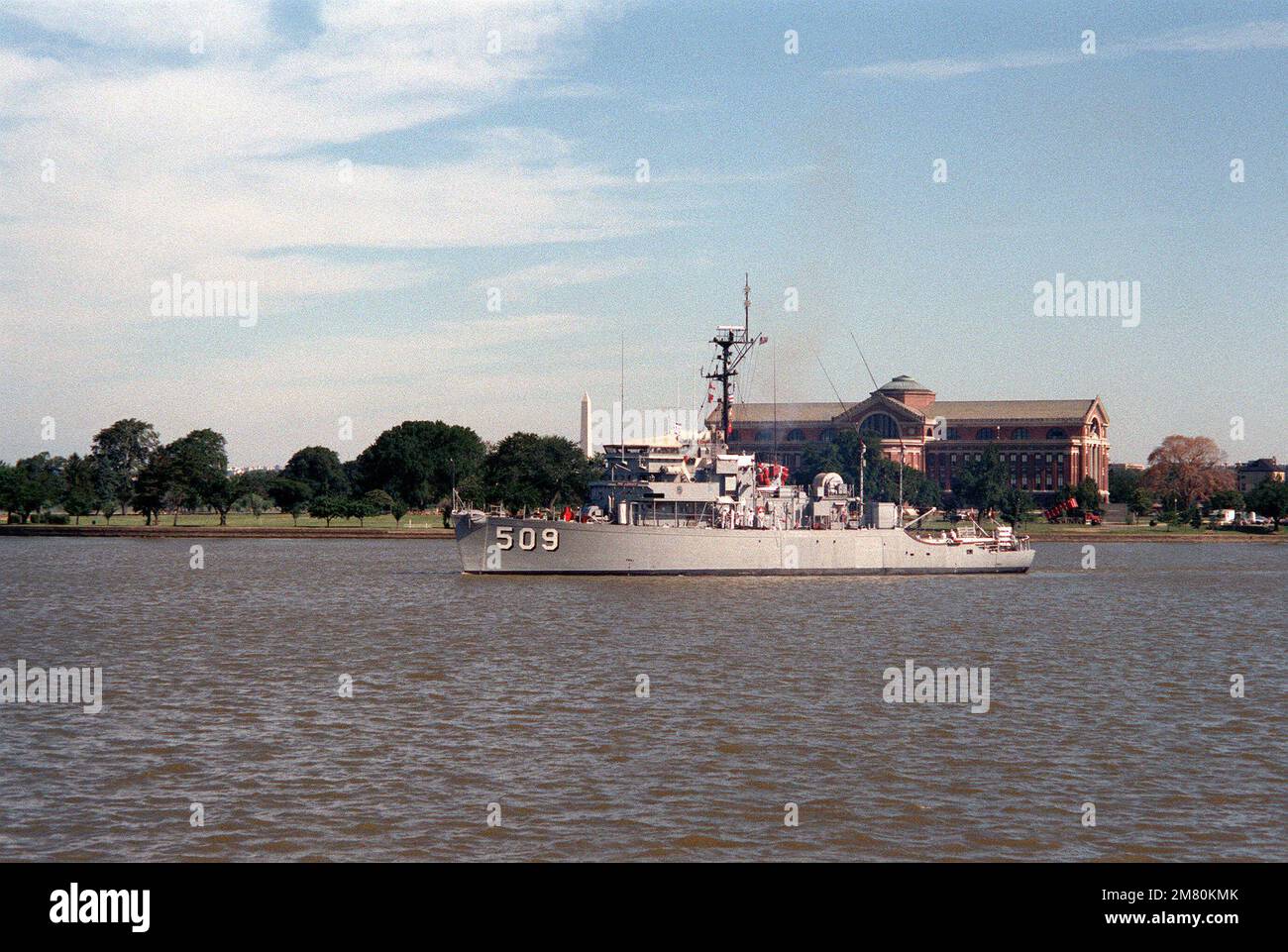 A port beam view of the ocean minesweeper USS ADRIOT (MSO-509) passing ...