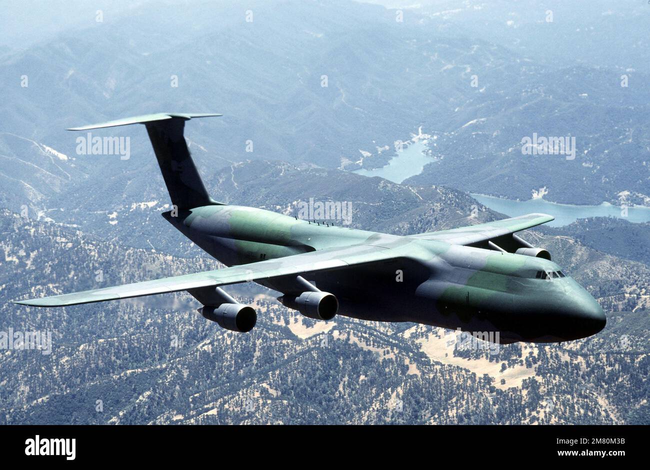 An air-to-air right front view of a C-5 Galaxy aircraft, in a ...