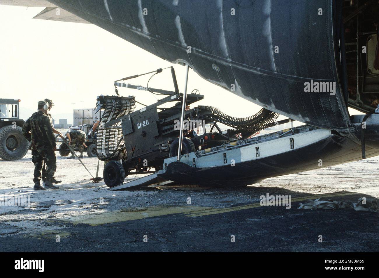 A 30 mm cannon loader is loaded aboard a C-130 Hercules aircraft during ...