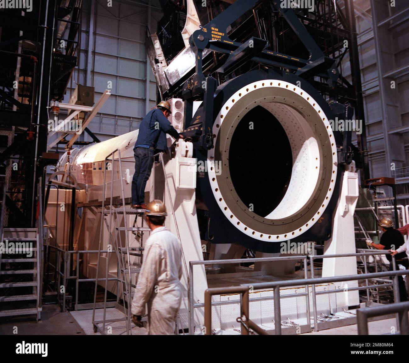 Technicians watch as an LGM-118A Peacekeeper missile launch canister is ...