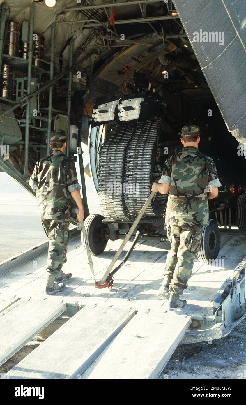 A 30 mm cannon loader is loaded aboard a C-130 Hercules aircraft during ...